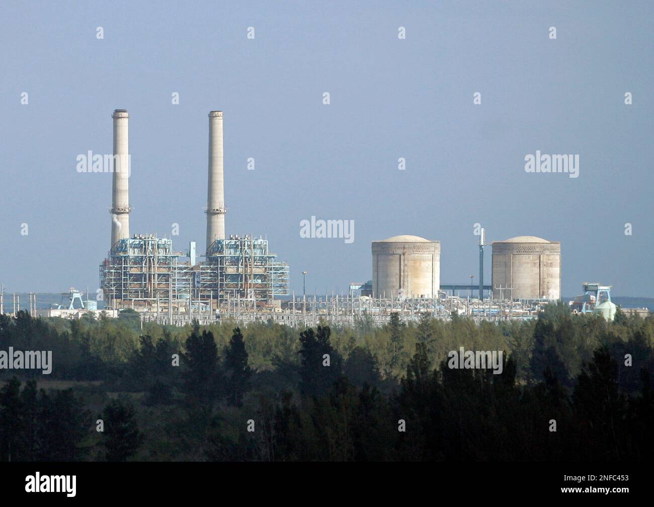 The containment buildings, right, and the smokestacks for the fossil ...