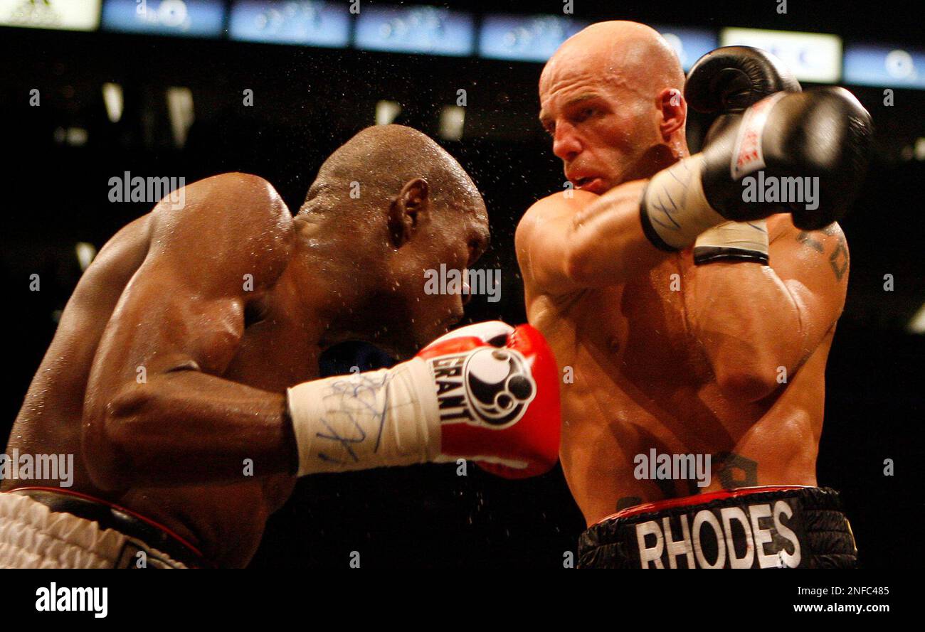 British middleweight Ryan Rhodes, right, punches South African Vincent ...