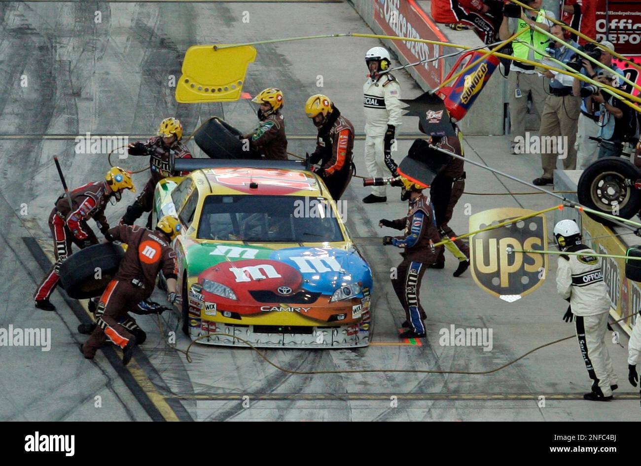 NASCAR driver Kyle Busch in the M&M's Toyota comes in for a pit stop ...