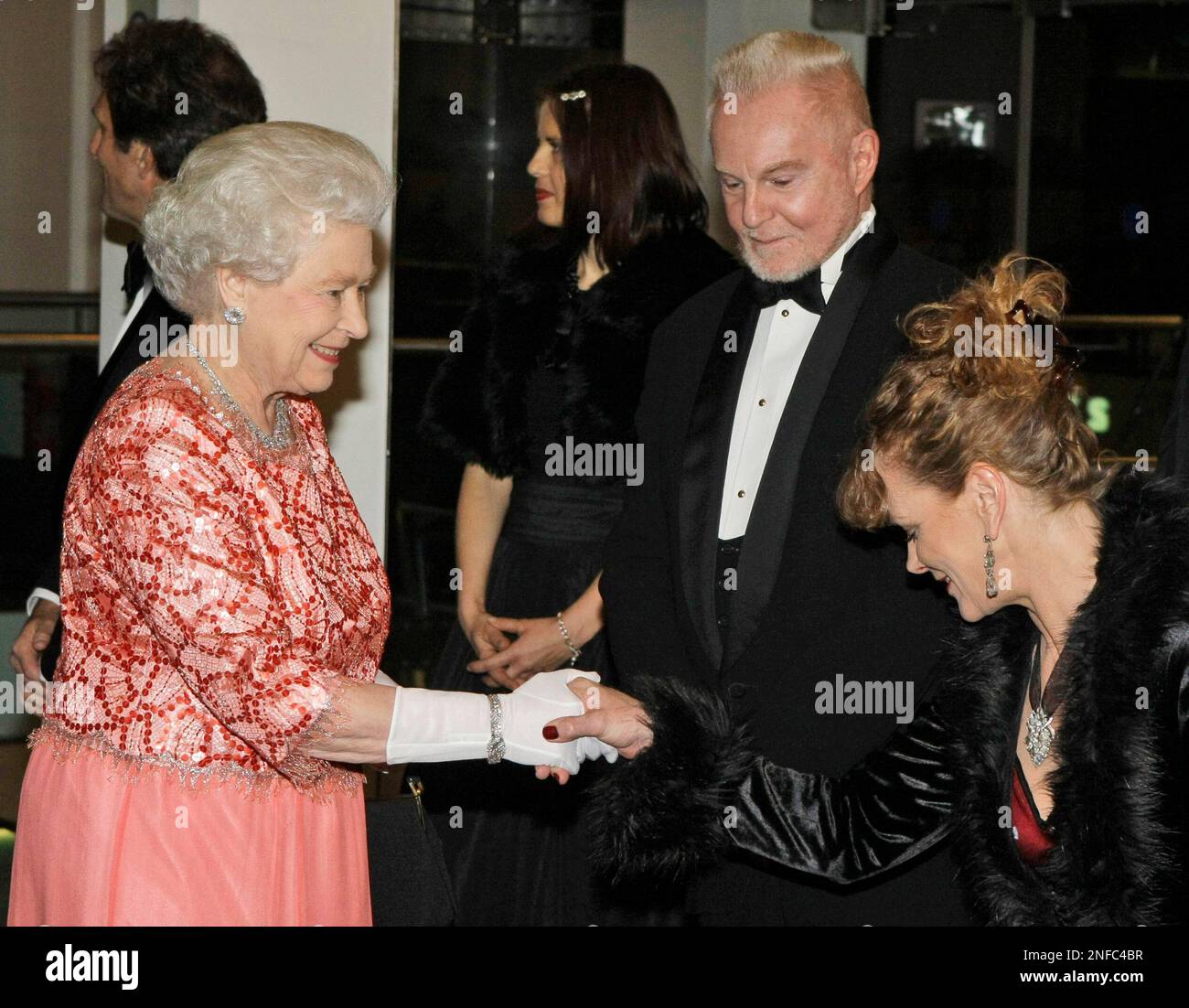 Britain's Queen Elizabeth II, left, meets cast members, from left ...