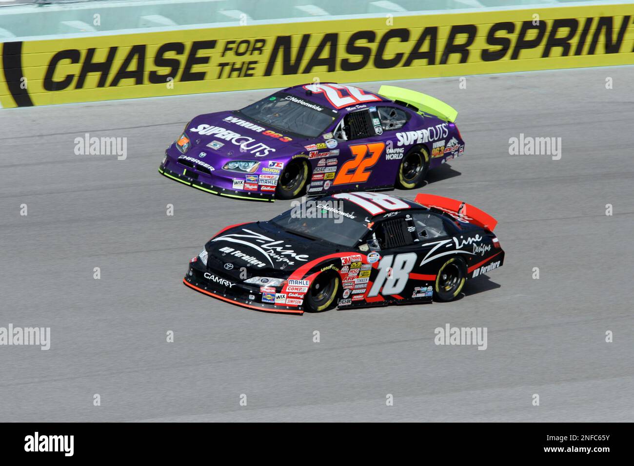 Marc Davis in the Supercuts car and Kyle Busch driving a practice lap ...