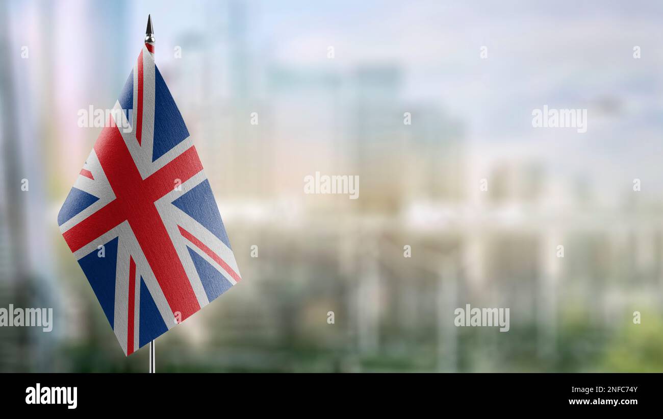Small flags of the United Kingdom on an abstract blurry background ...