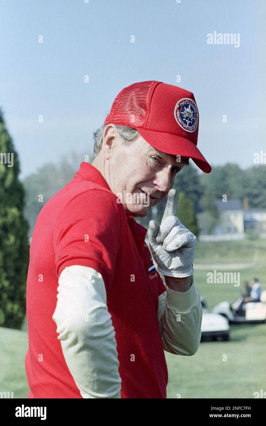President George Bush gestures playfully to photographers while playing ...
