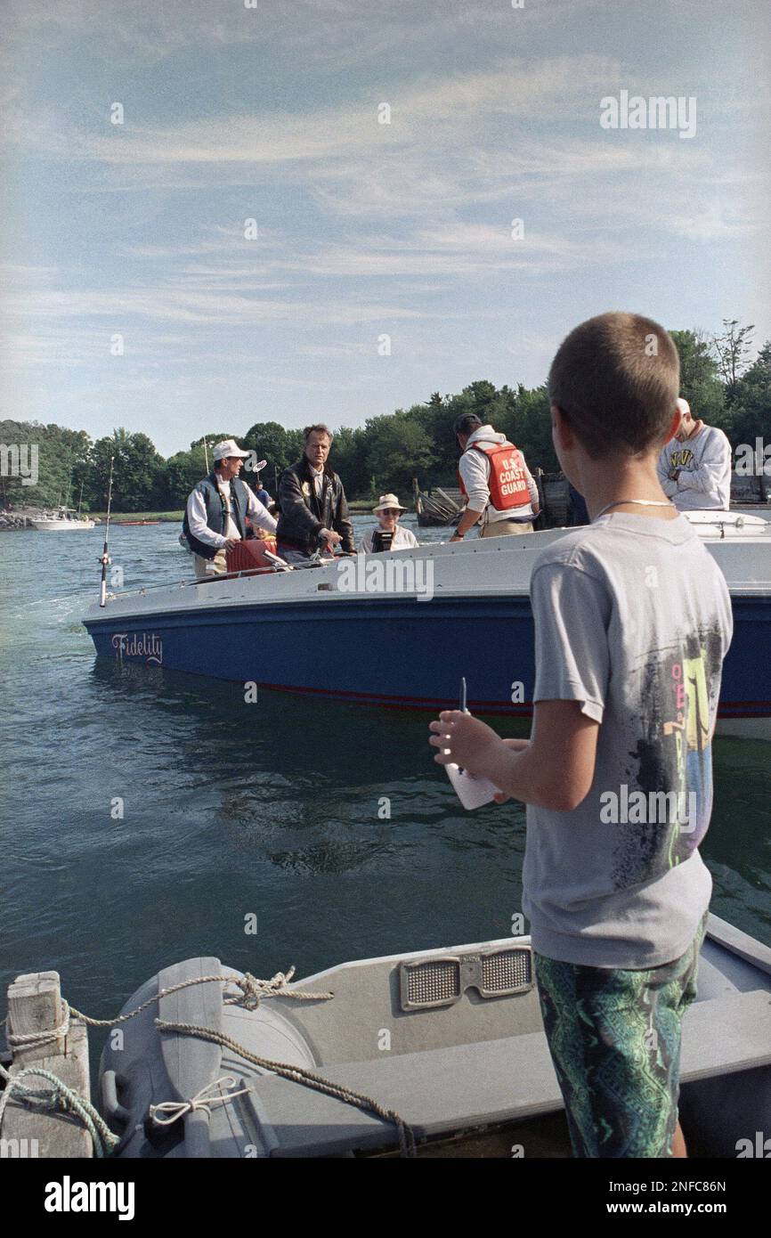 President George Bush maneuvers his boat Fidelity toward young ...