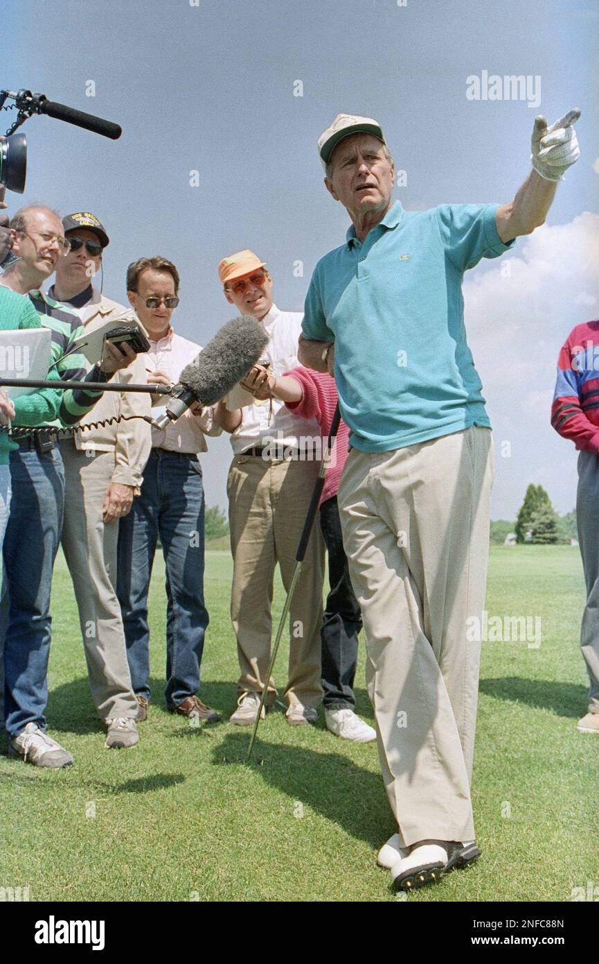 President George Bush talks with reporters after finishing a round of ...