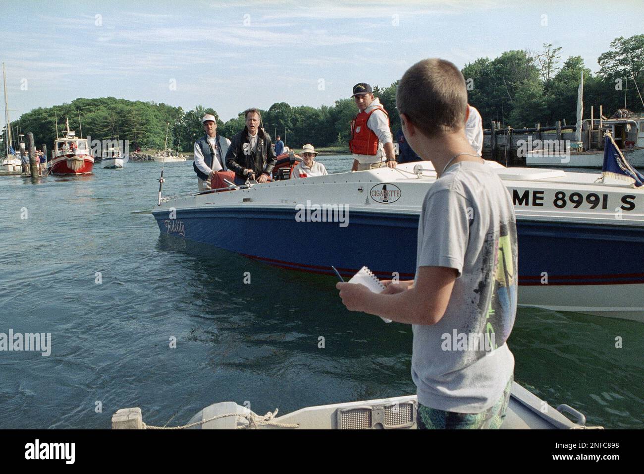 President George Bush maneuvers his boat Fidelity toward young ...