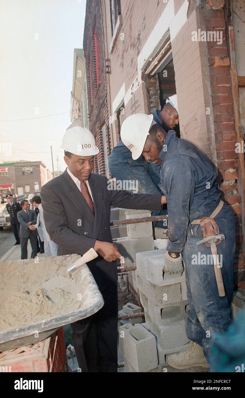 Philadelphia Mayor W. Wilson Goode, left, points to a cinder block as a ...