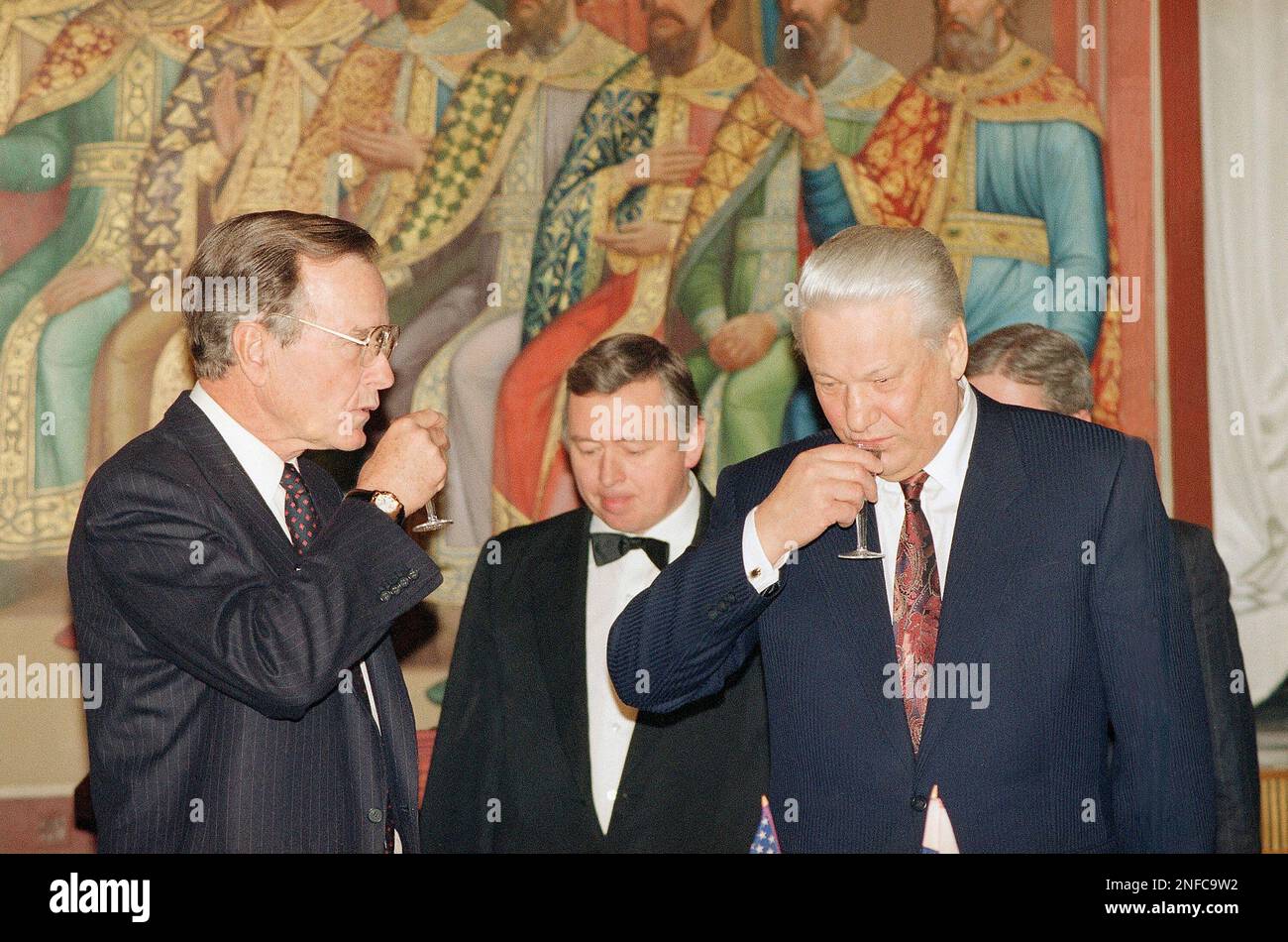 U.S. President George H. Bush tosses back his glass of vodka along with ...