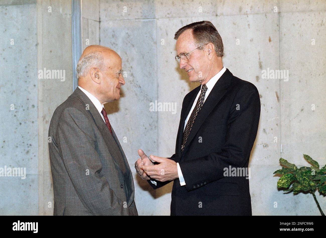 U.S. President George H. Bush points as he greets Dr. Haider Abdul ...