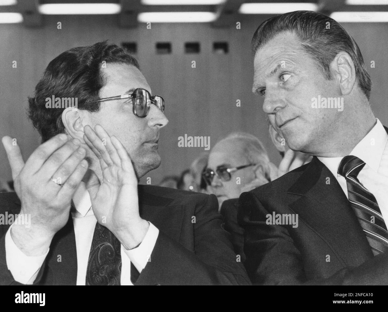 West German interior minister, Gerhart Baum, left, claps his hands as ...