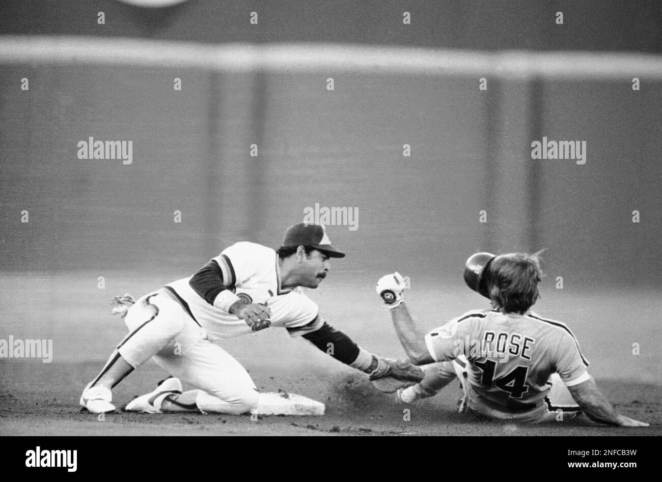 Philadelphia Phillies Pete Rose (14) tries to slide around the tag of ...