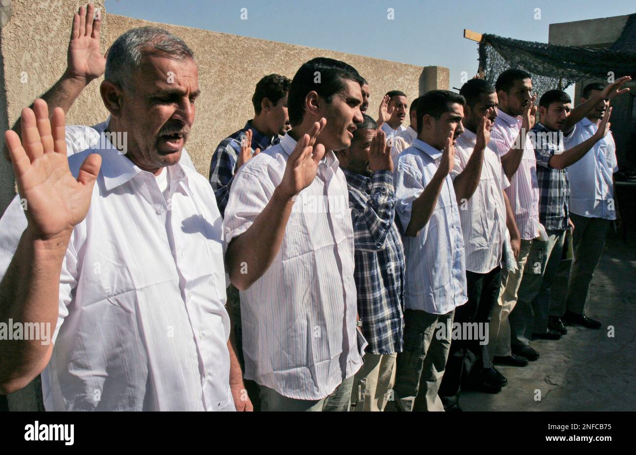 Iraqi men make a pledge after they were released from U.S. military ...
