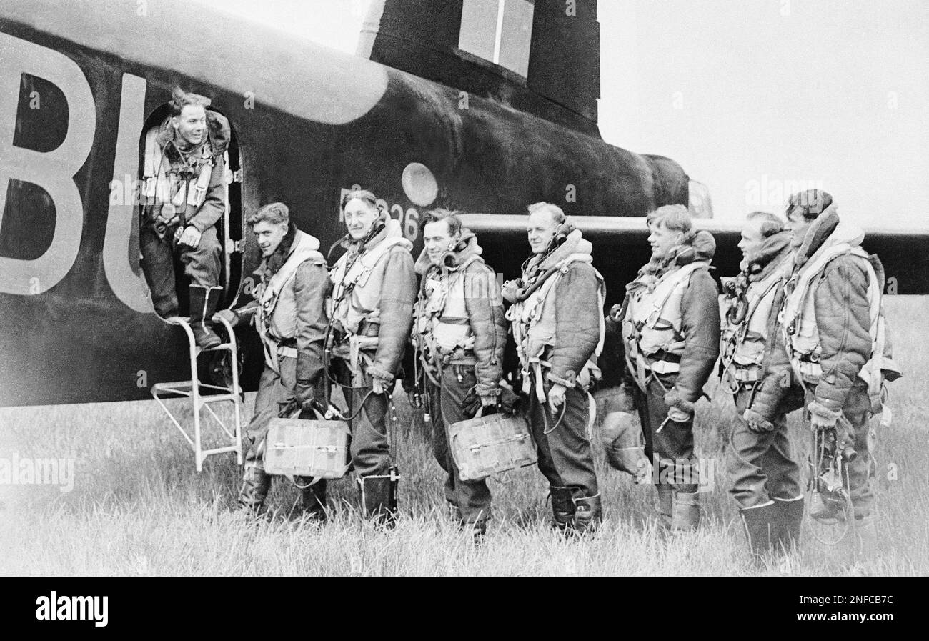 The crew of a Stirling bomber lines up on an English field for the ...