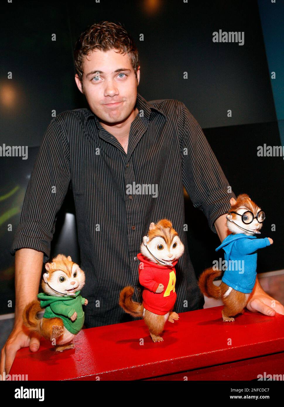 Singer Drew Seeley is pictured with wax figures of Alvin and the ...
