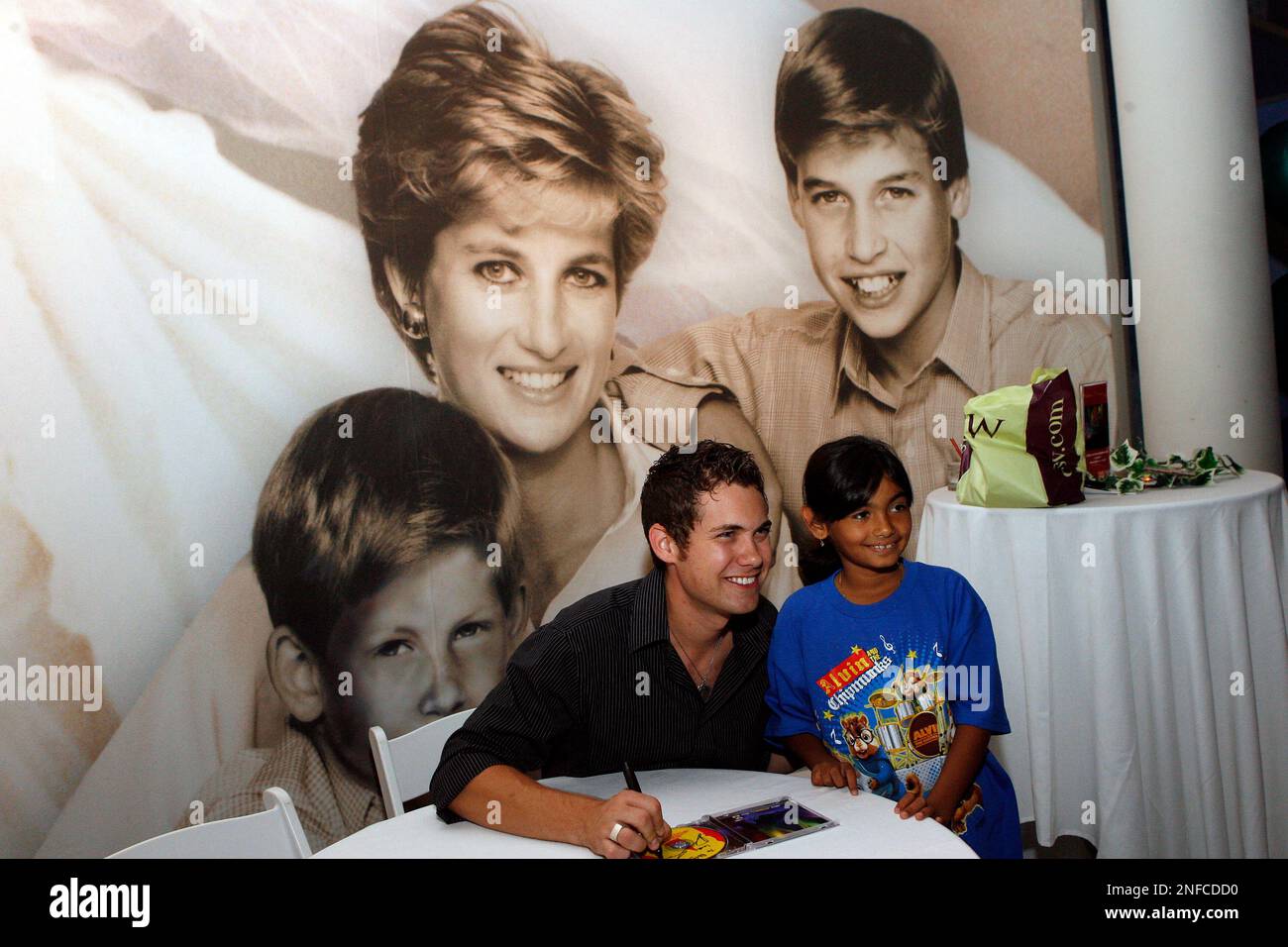 Singer Drew Seeley poses for a photo with Daniela Delgado, 8, at the ...