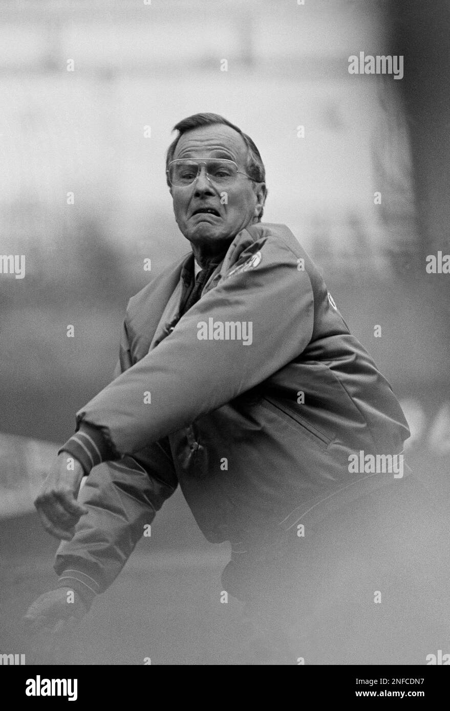 Vice President George Bush grimaces as he follows through after ...