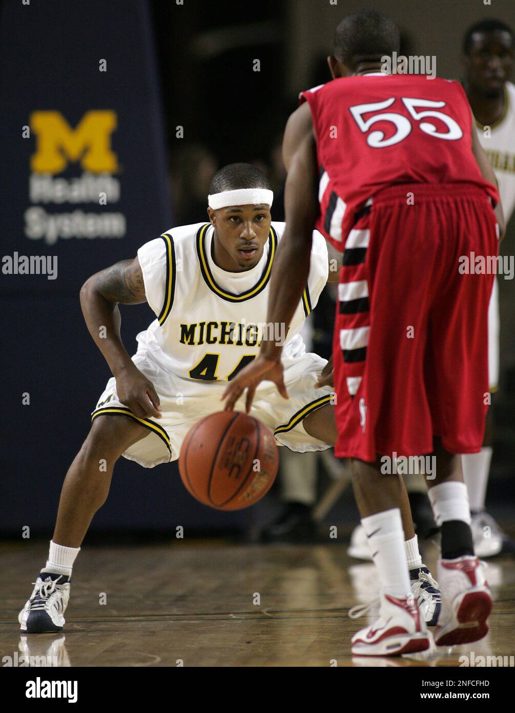 Michigan guard Kelvin Grady (44) defends Saginaw Valley State guard ...