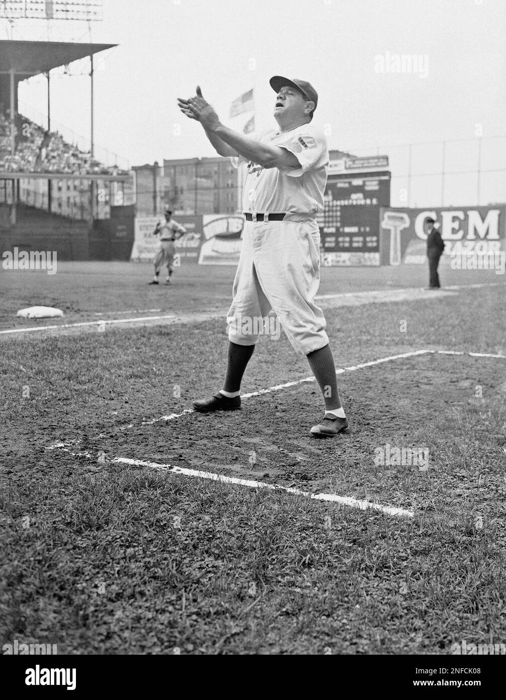 Babe Ruth directs play from the coaching box shortly before being ...