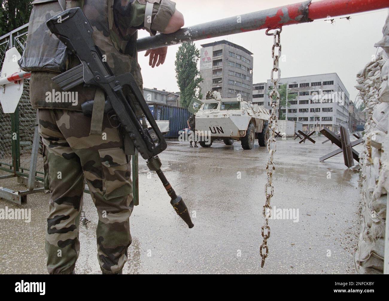 A French UN peacekeeper, carrying an anti-tank rocket attached to his ...