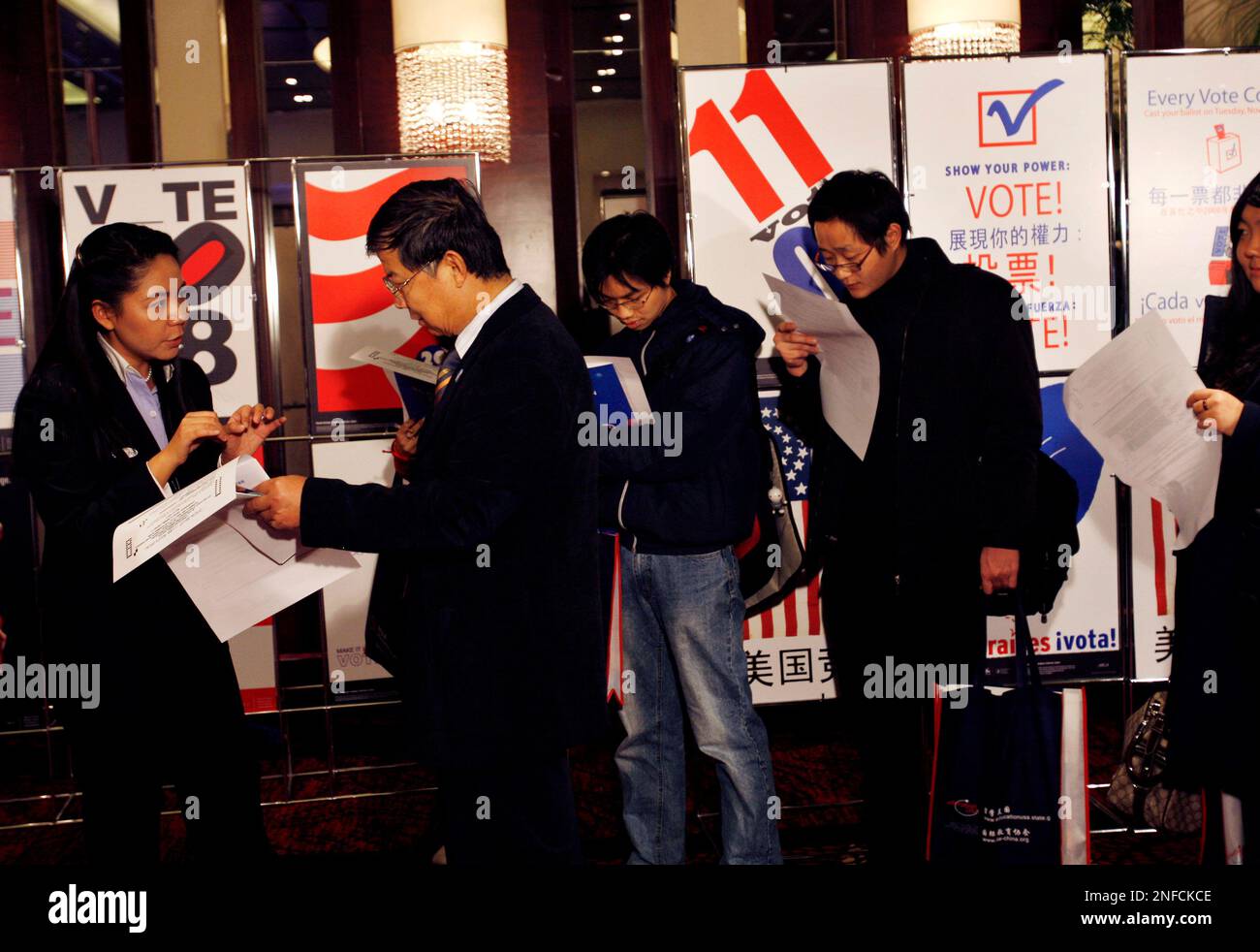 Chinese are shown how to vote at a mock election voting booth set at a ...