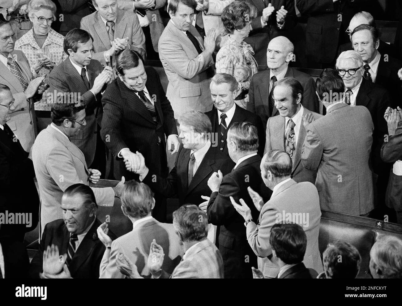 Pres. Jimmy Carter, center, walks down the aisle in the House Chamber ...