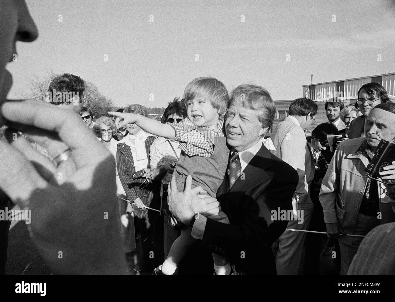 Jason Cater, two-year-old grandson of President Jimmy Carter, points to ...