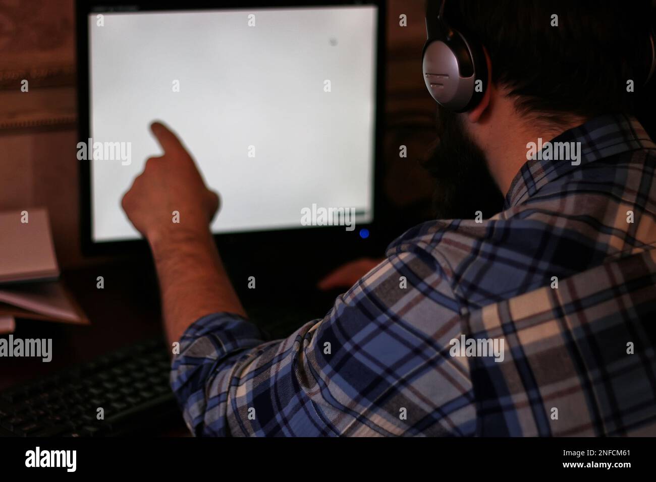 man play computer with headphones Stock Photo - Alamy