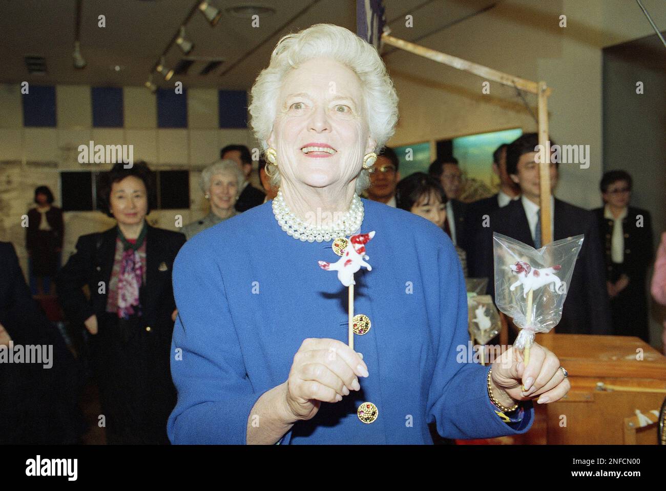 First lady Barbara Bush displays two candies in the shape of Rover and ...