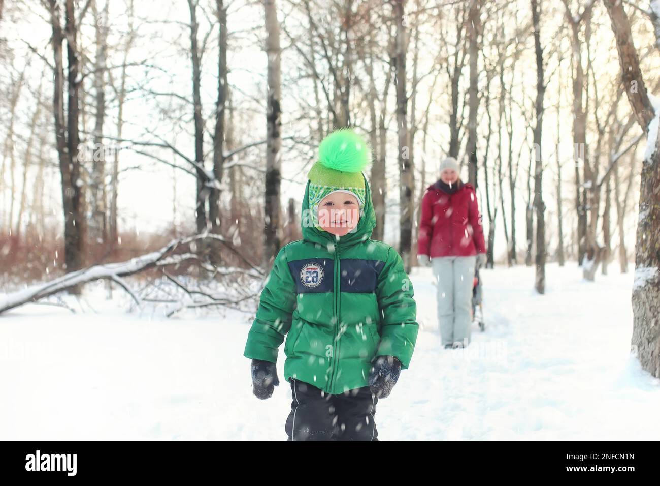 Family with children in the park in winter snow blizzard Stock Photo ...