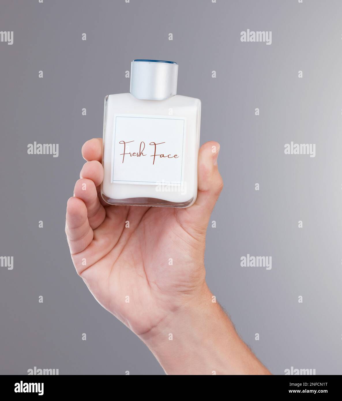Skincare, hand with bottle of cream for face and mock up isolated on ...
