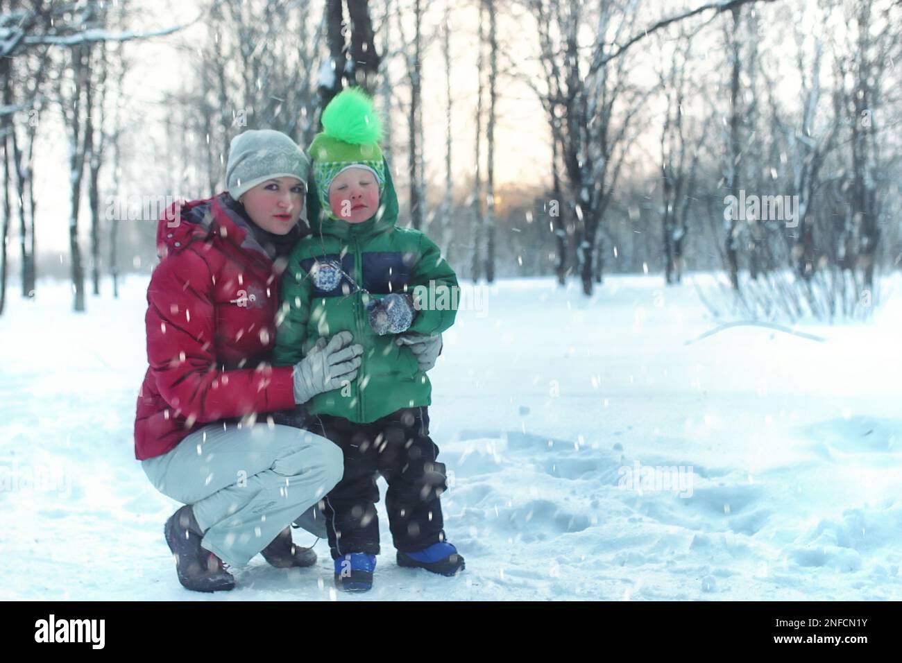 Family with children in the park in winter snow blizzard Stock Photo ...