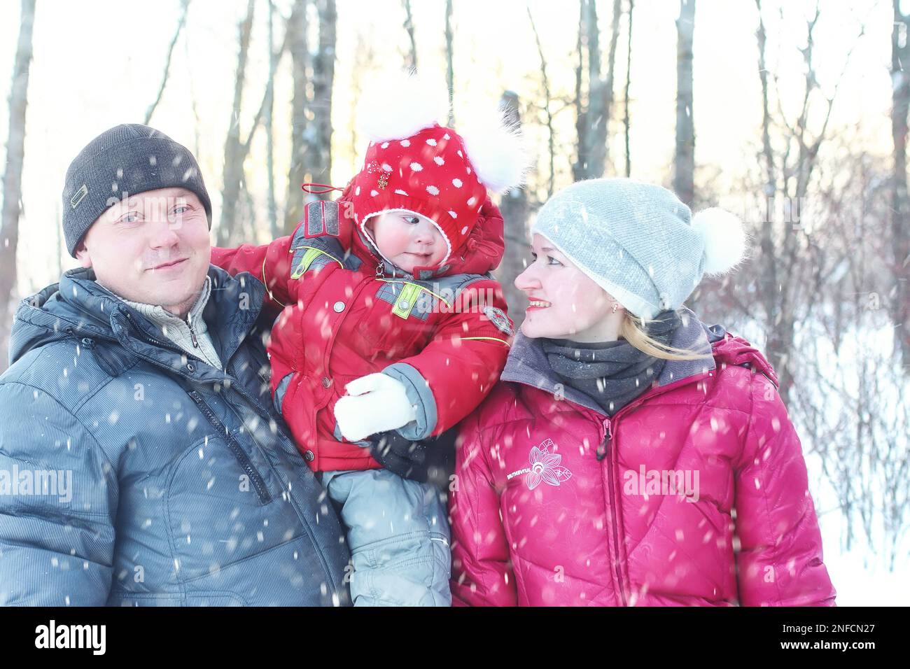 Family with children in the park in winter snow blizzard Stock Photo ...