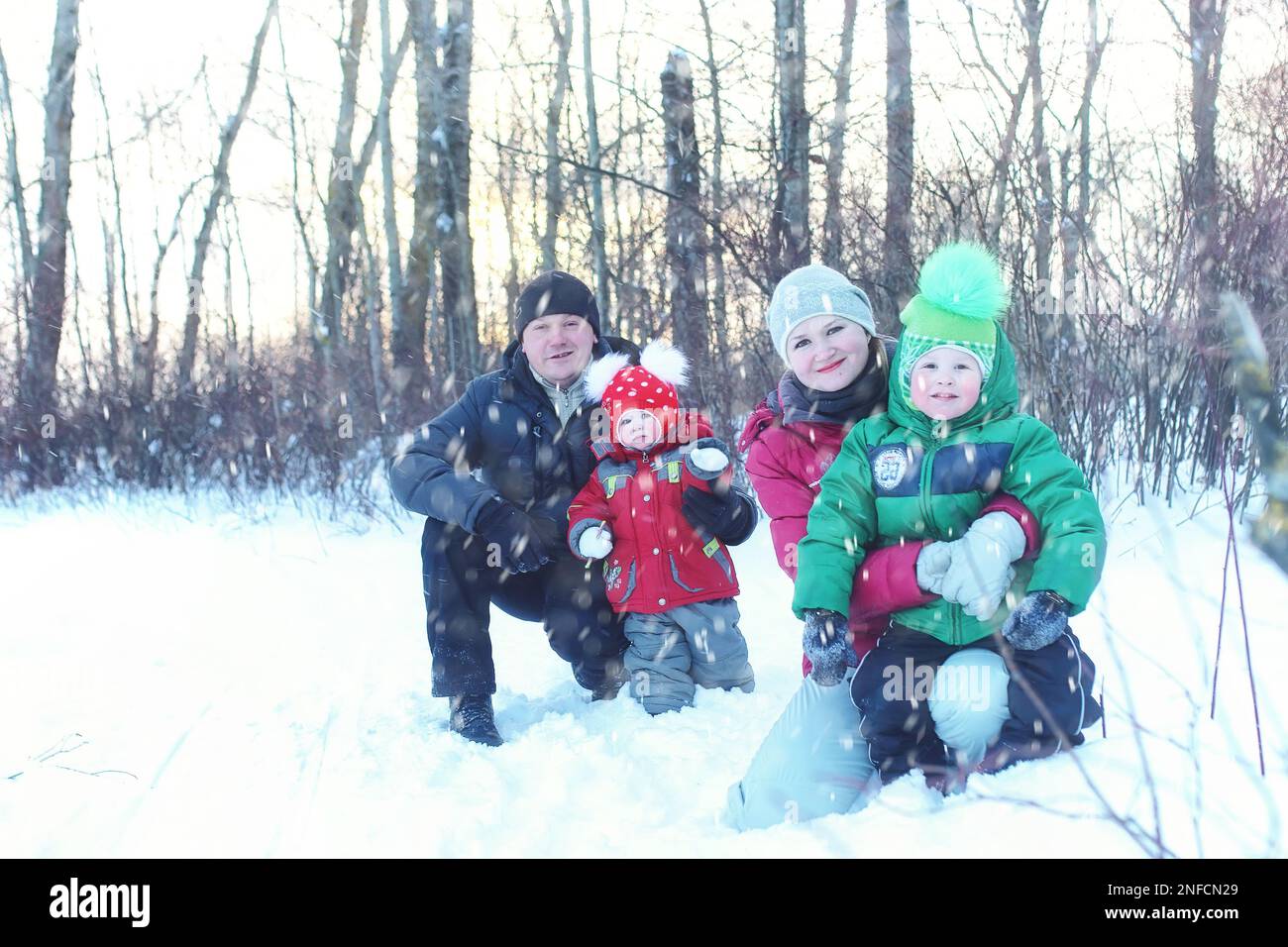 Family with children in the park in winter snow blizzard Stock Photo ...