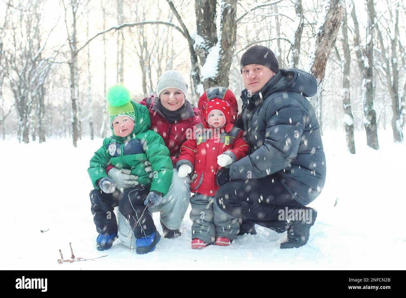 Family with children in the park in winter snow blizzard Stock Photo ...