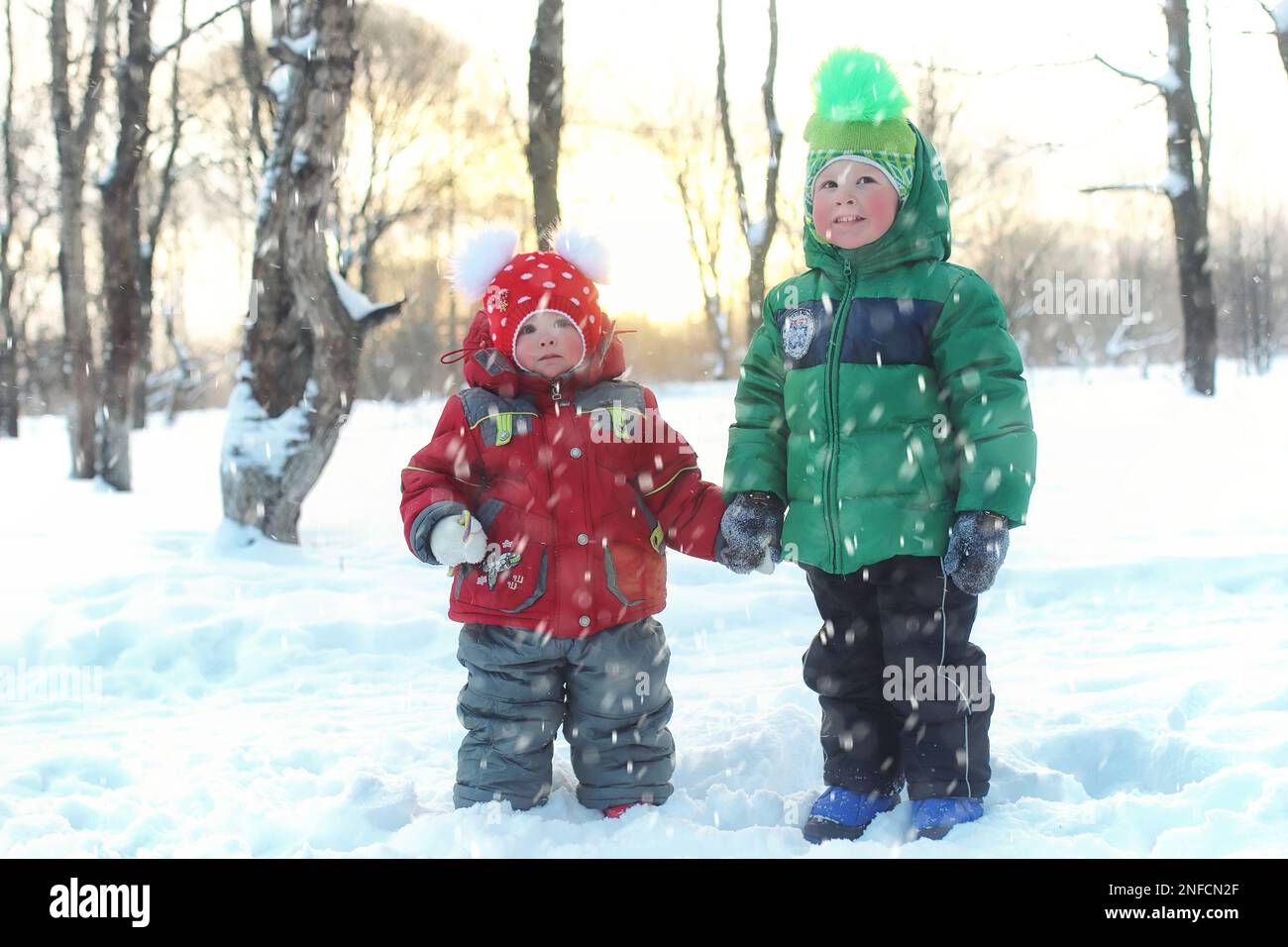 Family with children in the park in winter snow blizzard Stock Photo ...