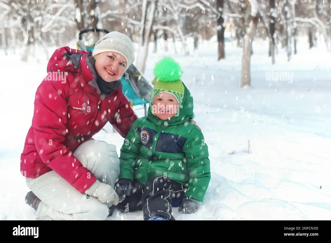 Family with children in the park in winter snow blizzard Stock Photo ...