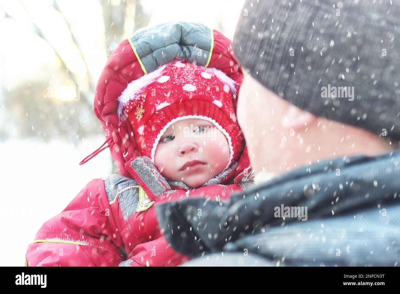 Family with children in the park in winter snow blizzard Stock Photo ...
