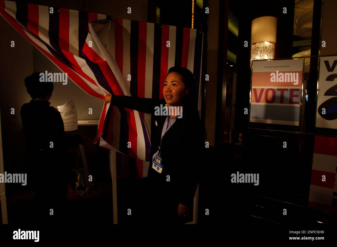 Chinese casts their mock ballot at an election voting booth set at a US ...