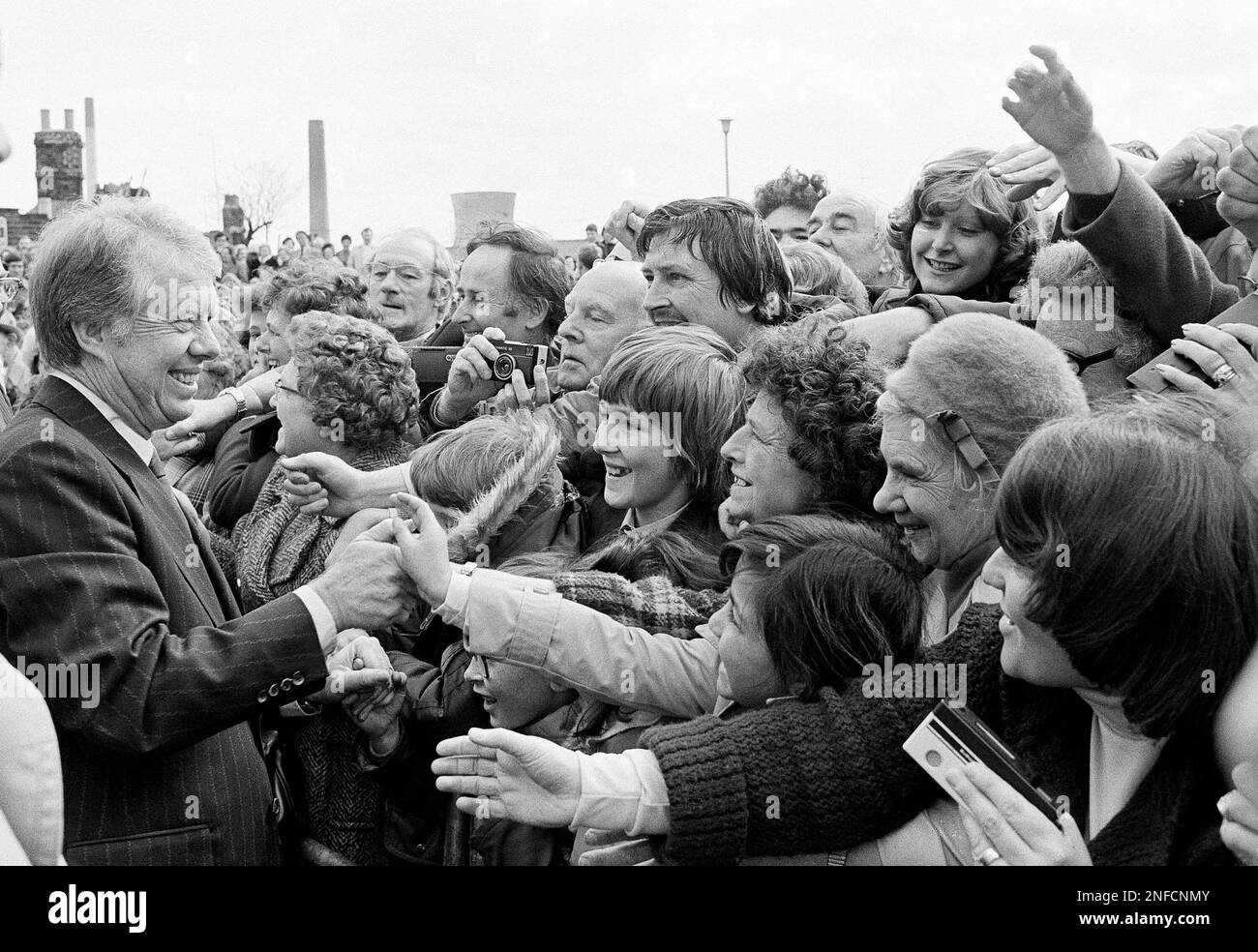 U.S. President Jimmy Carter is welcomed by spectators as he arrives at ...