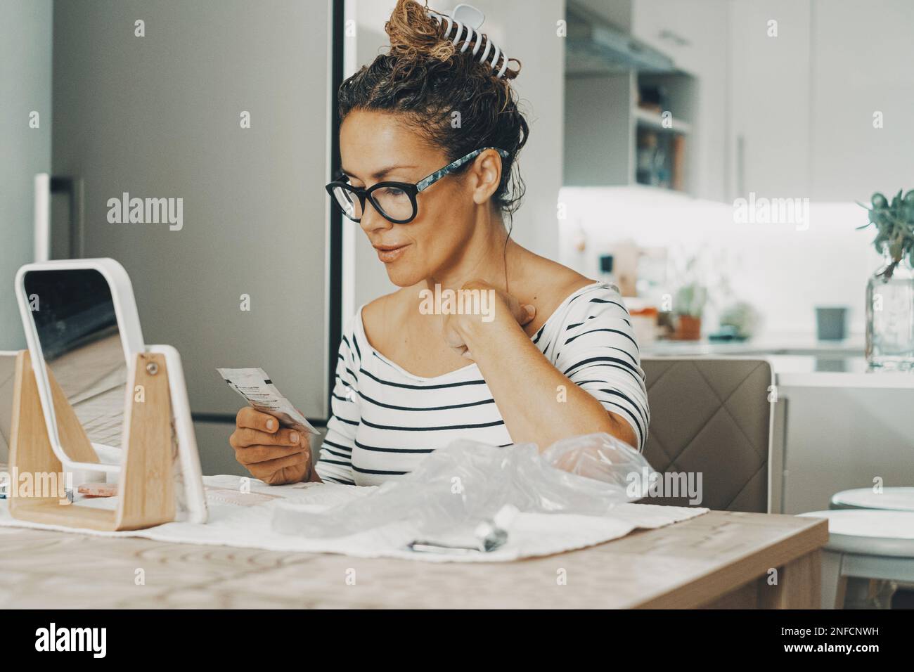 Mid age female ready to apply hairstyle colours on her long hair ...