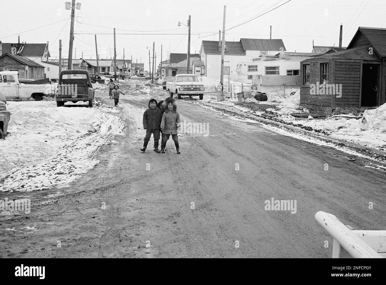 Inuit children, bundled up against the Arctic cold, are pictured on one ...