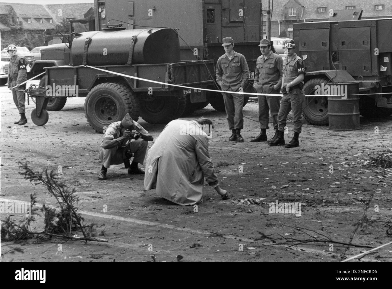A police officer is pictured investigating the site of yesterday's car ...