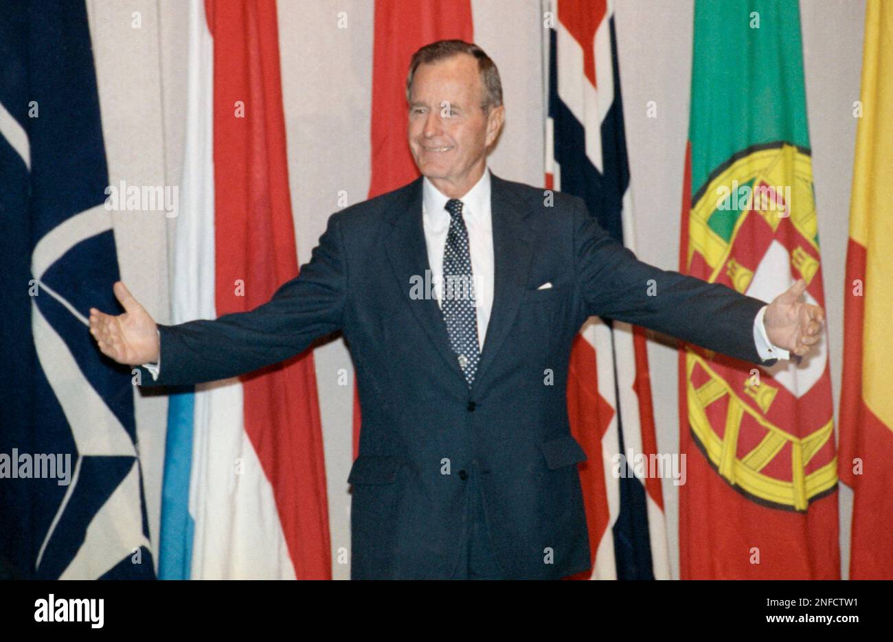 U.S. President George Bush stretches out his arms to welcome the other ...