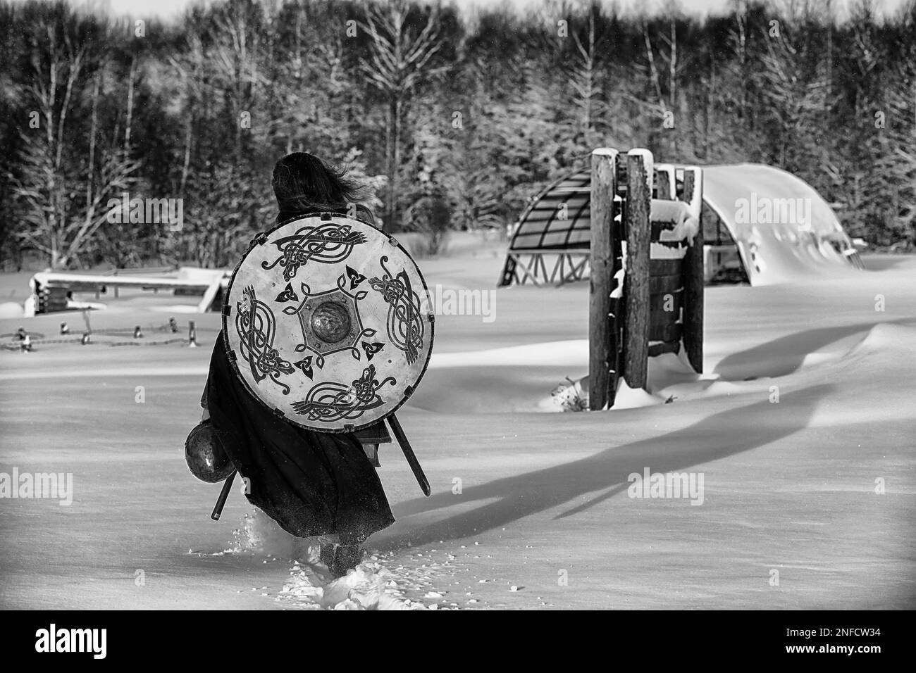 Defender the young warrior in mail armor armed with a sword and an ax ...