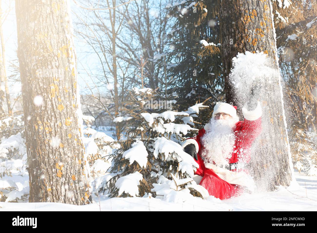 Santa Claus comes with gifts from the outside. Santa in a red suit with ...