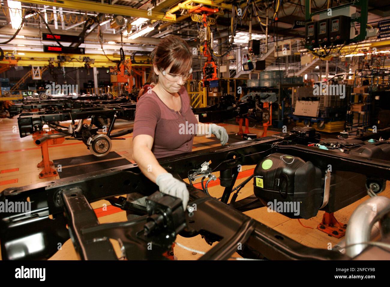 Ford lineworker Carey Earl works on the 2009 Ford F150 truck at the ...