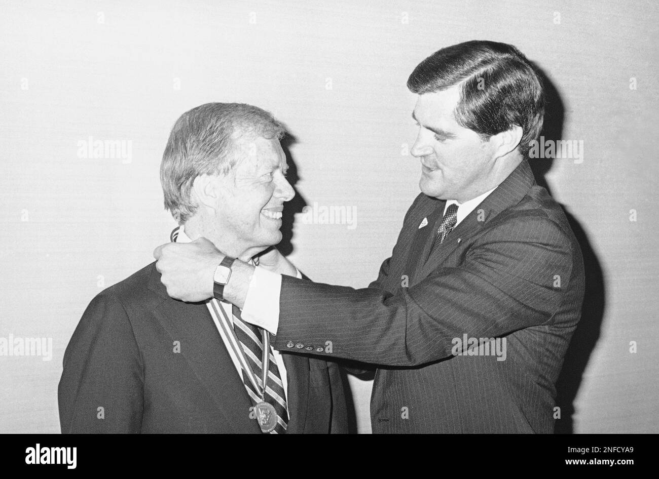 Former President Jimmy Carter, left, is presented the Georgia Medal by ...