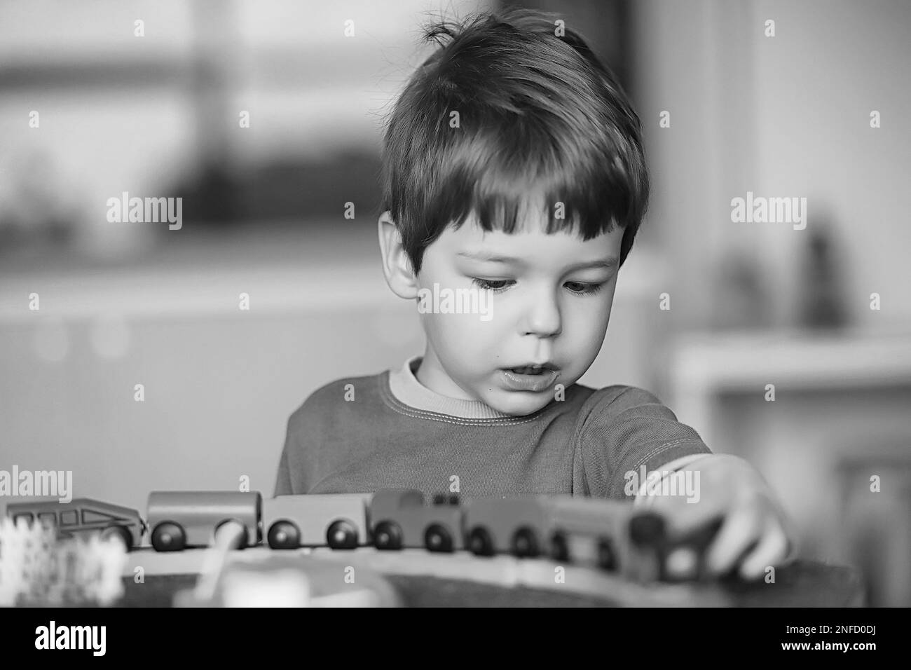 Child in the children's room. The kid is sitting on the windowsill at ...
