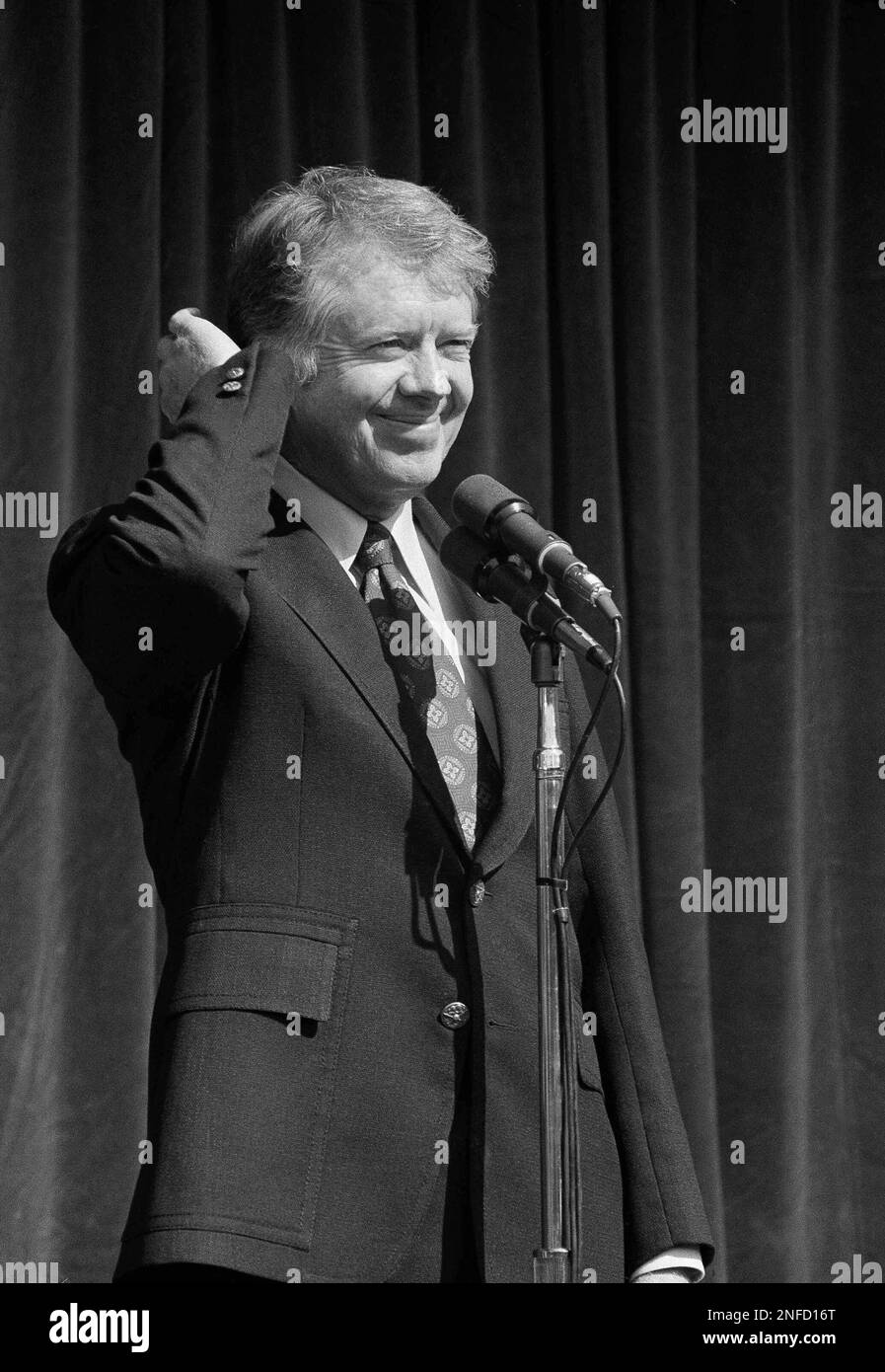 Pres. Jimmy Carter keeps brushing his hair with his hands while ...