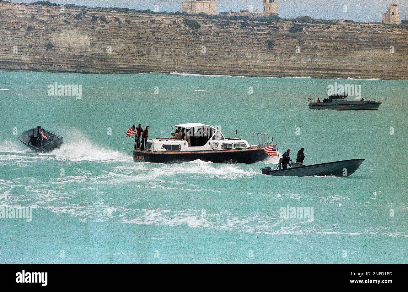 U.S. Marine commando boats escort President George H. Bush aboard his ...